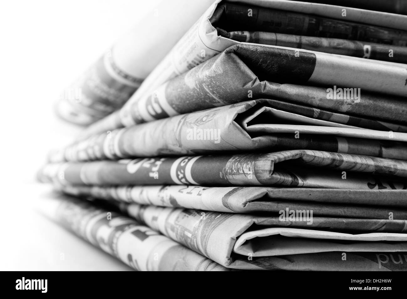 Closeup of newspapers on plain background Stock Photo - Alamy