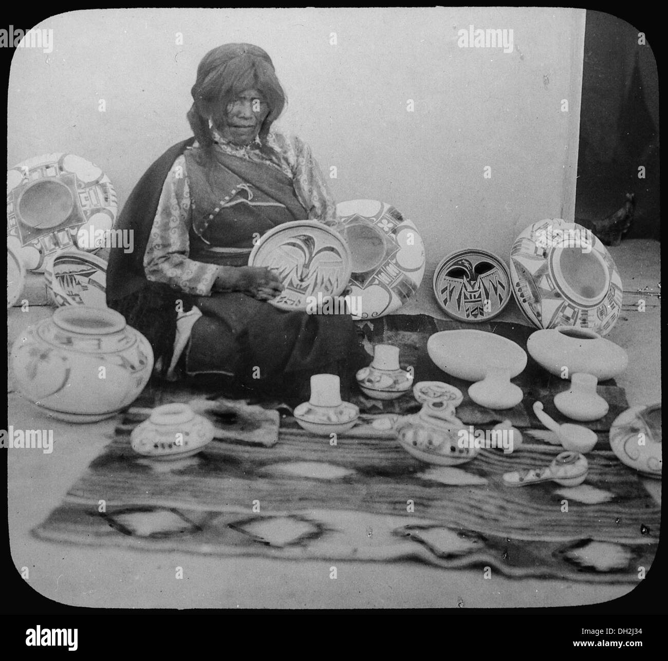 Nampeyo, a renowned Hopi pottery maker, sits surrounded by her ...
