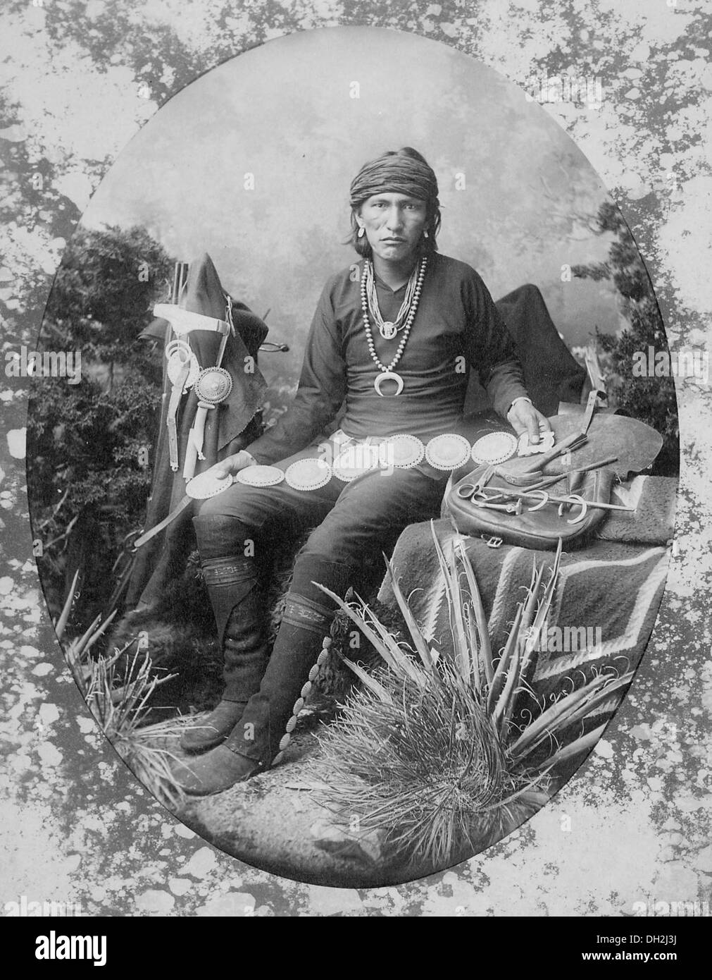 A Navajo silversmith from 1880 is shown with examples of his work ...
