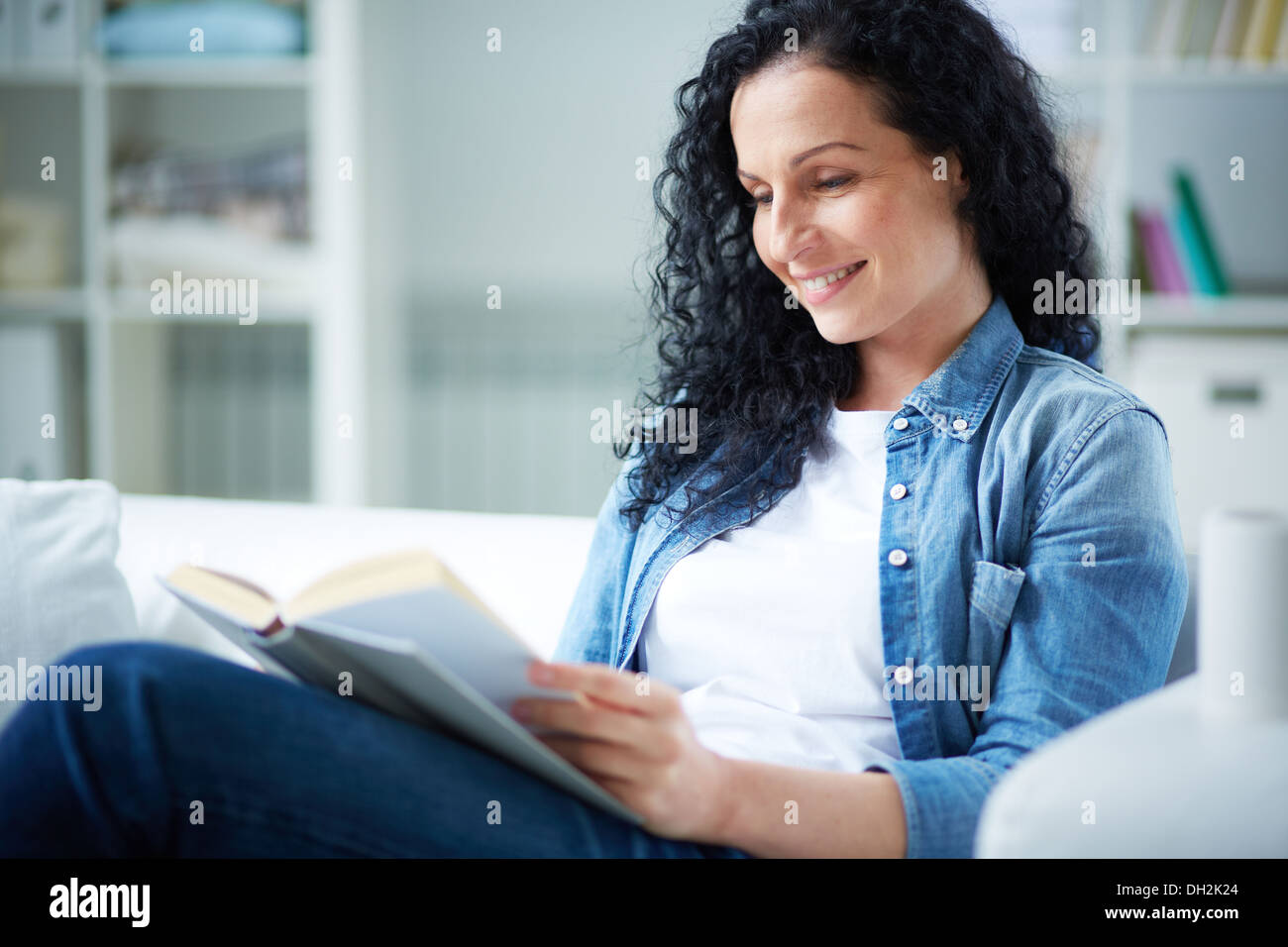 Happy brunette woman reading book hi-res stock photography and images ...