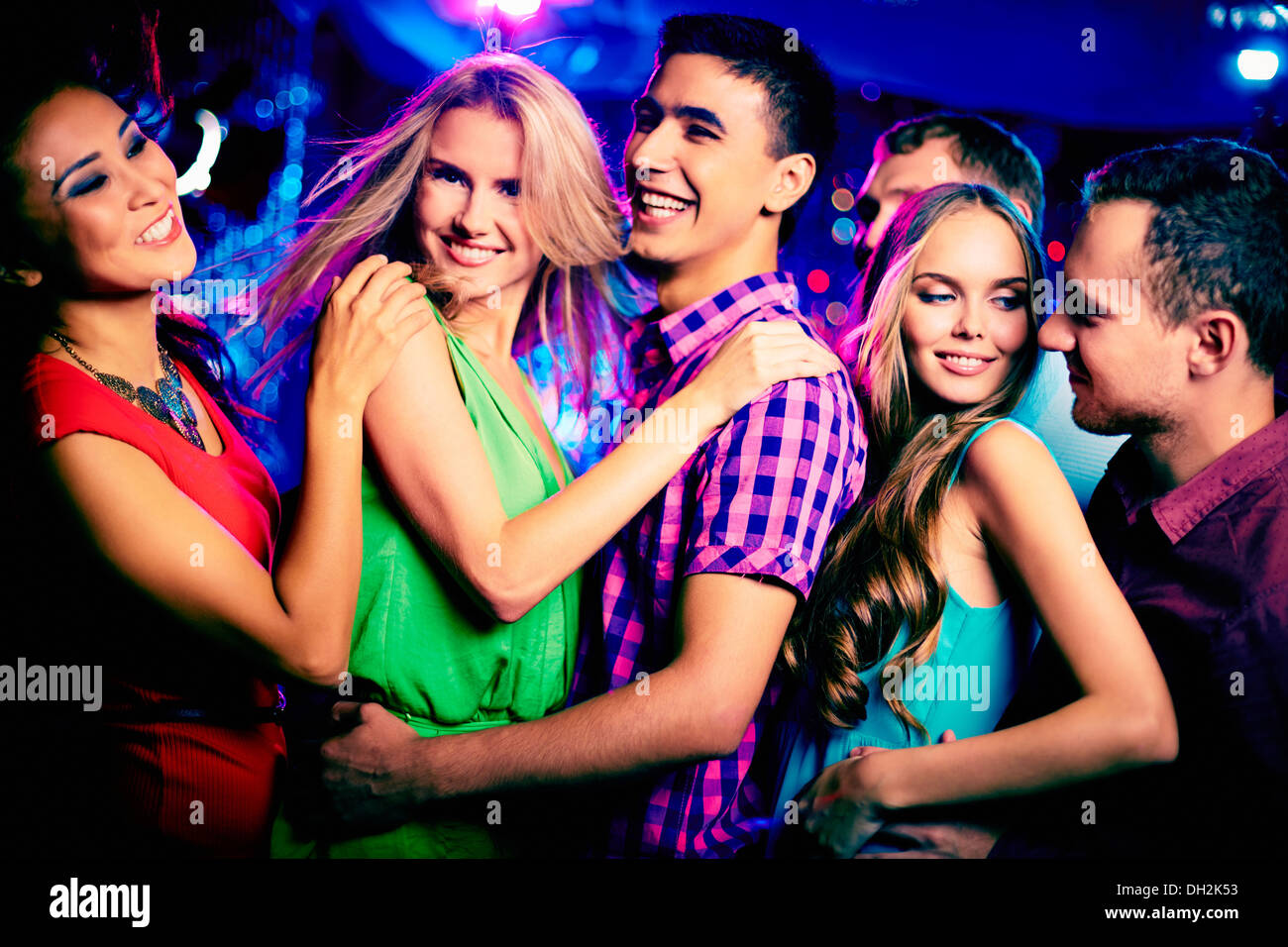 Happy young friends dancing at disco Stock Photo - Alamy