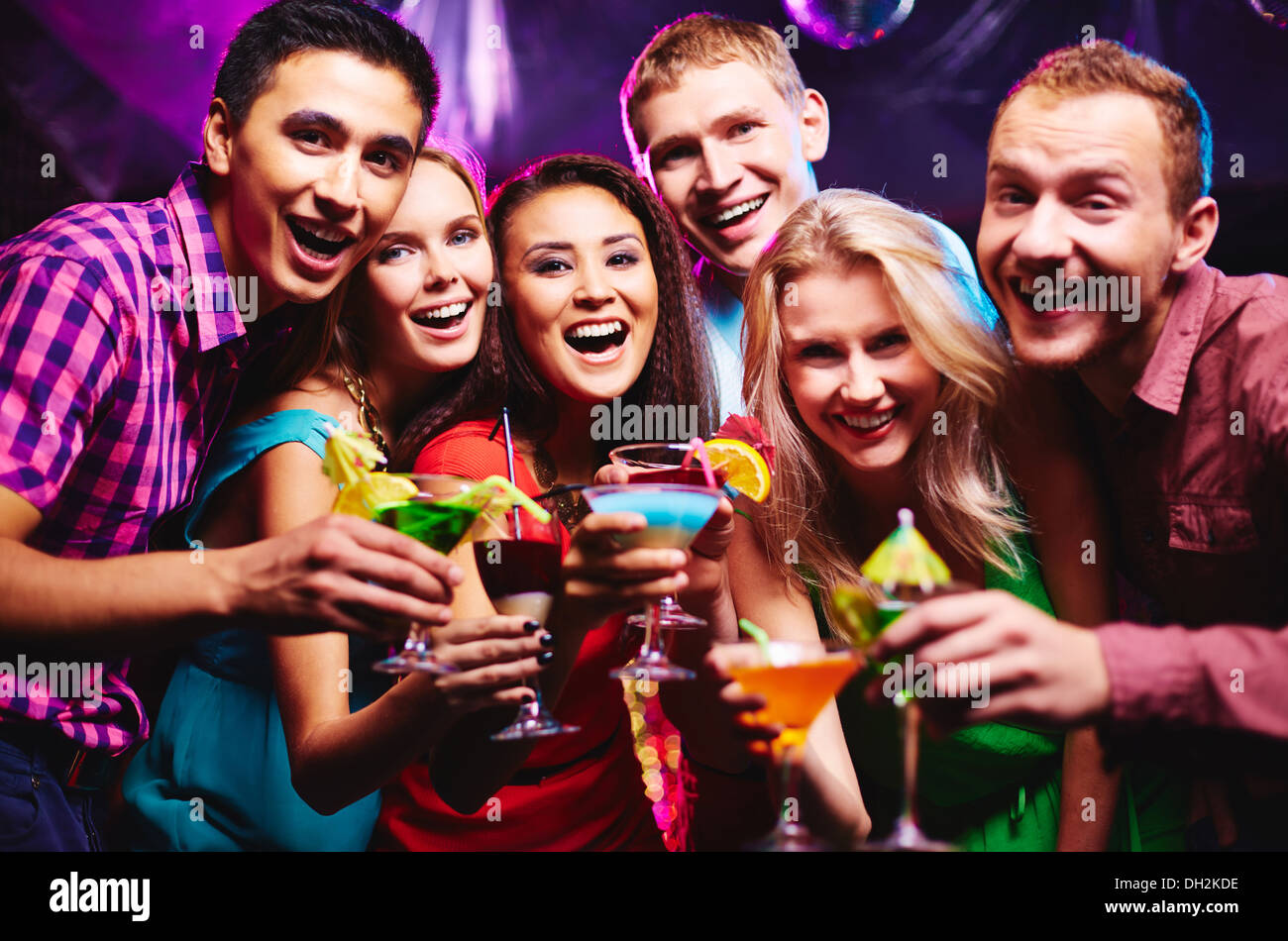 Group of happy friends with cocktails toasting at party Stock Photo - Alamy