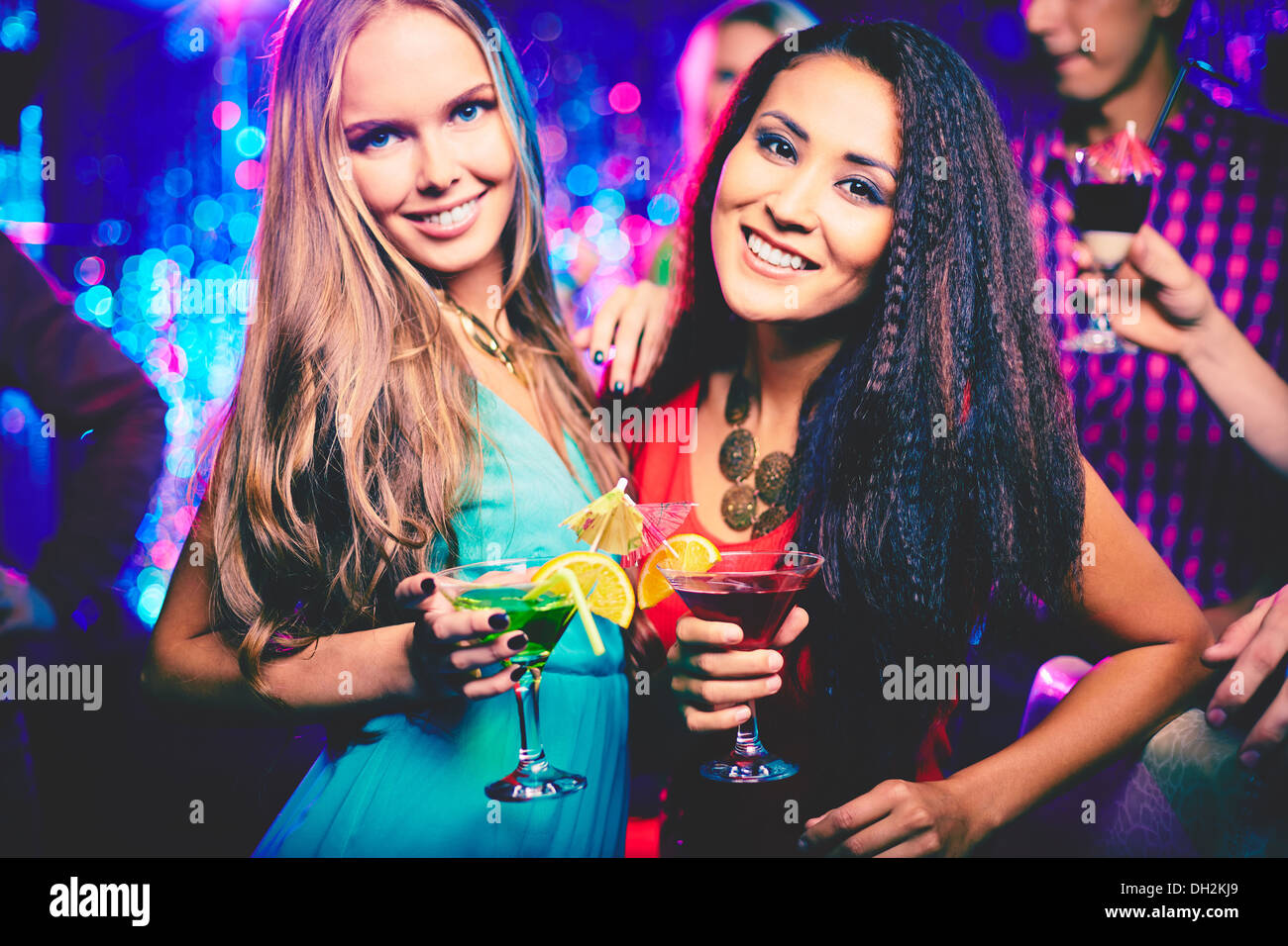 Portrait of happy girls with cocktails looking at camera at party Stock ...