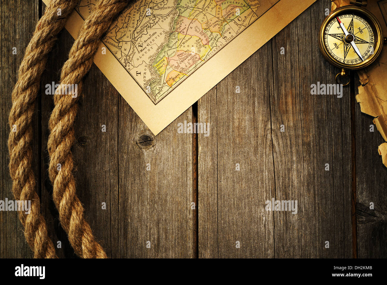 Antique compass and rope over old map Stock Photo - Alamy