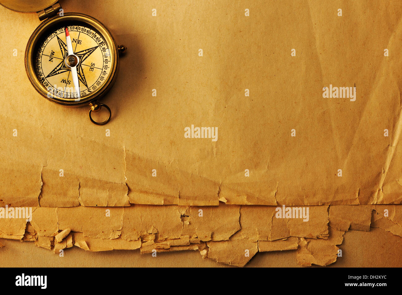 Antique brass compass over old background Stock Photo - Alamy