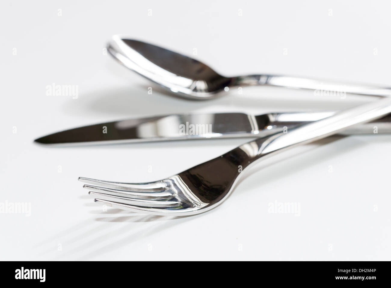 Close-up of a modern fork, knife, and spoon on a white background Stock ...
