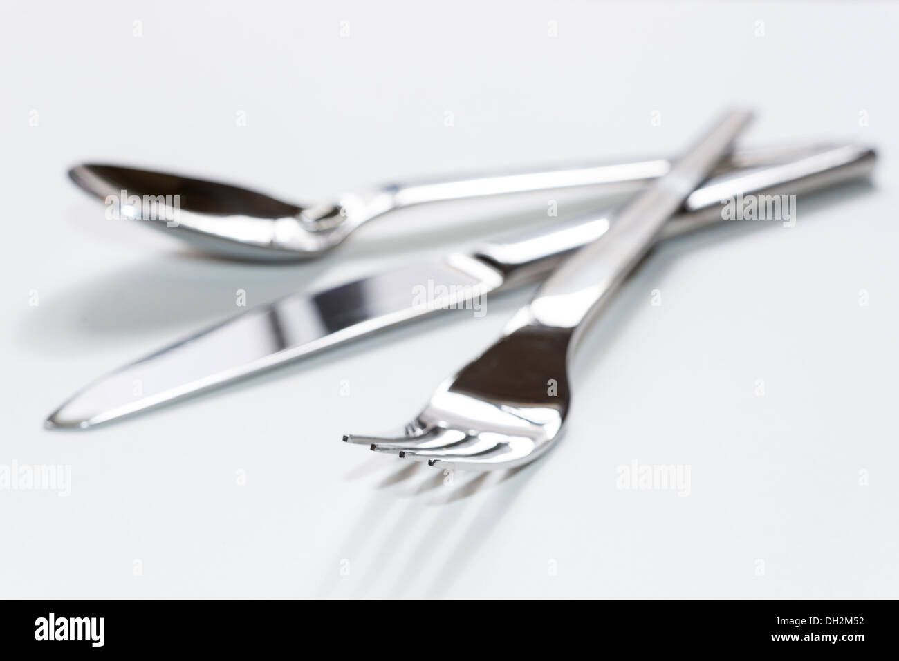 Close-up of a modern fork, knife, and spoon on a white background Stock ...