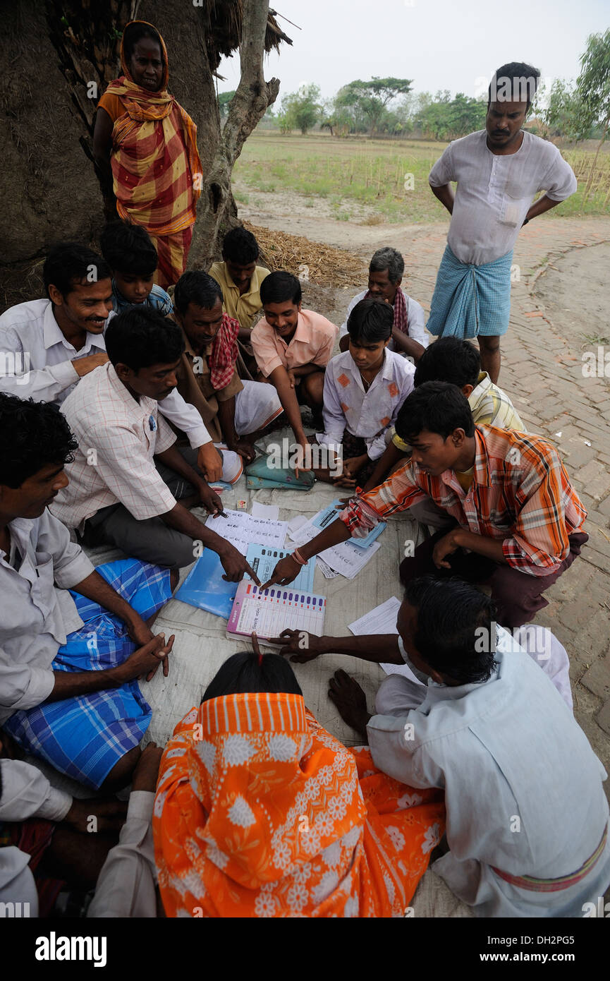 indian people learning political party workers explaining how to vote ...