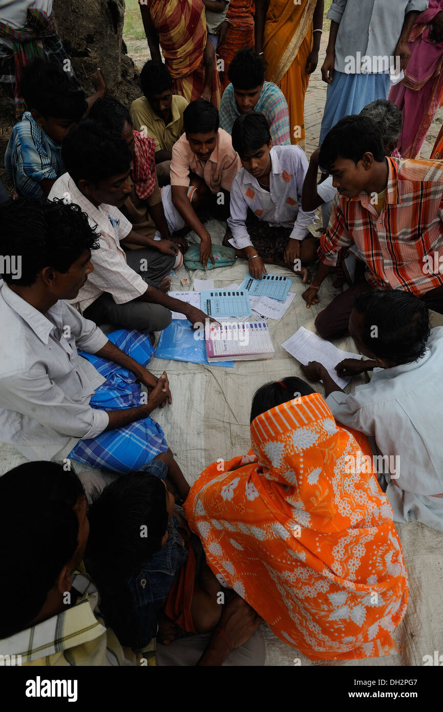indian people learning political party workers explaining how to vote ...