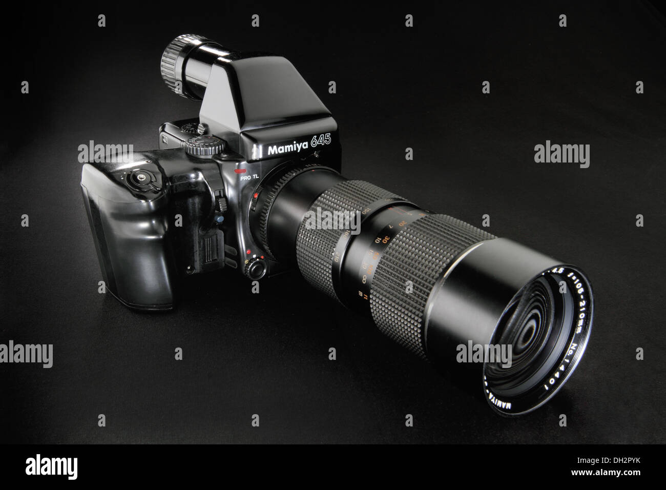 Film camera Mamiya 645 with long tele lens on black background Stock ...