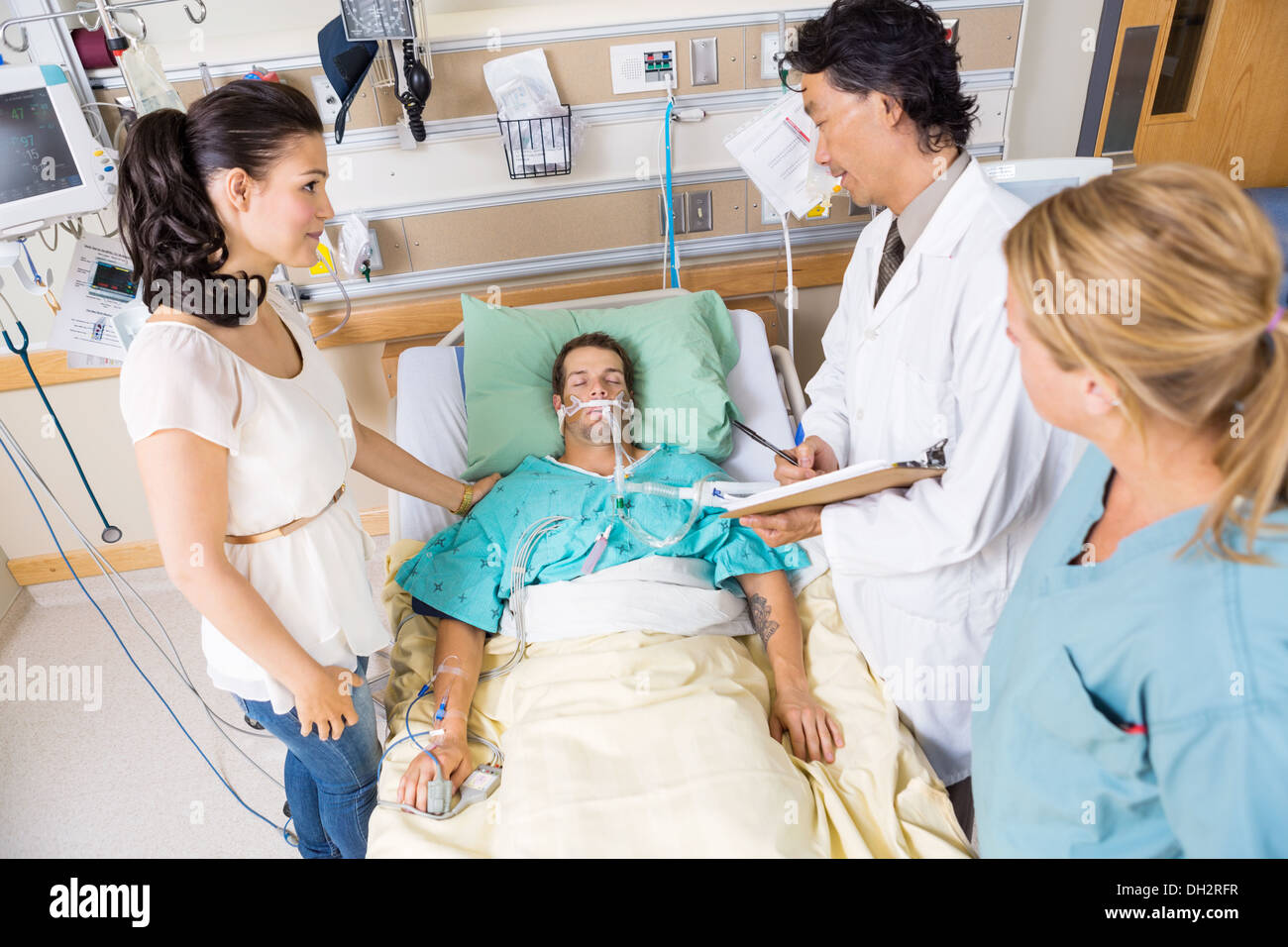 Critical care nurse looking at patient hi-res stock photography and ...