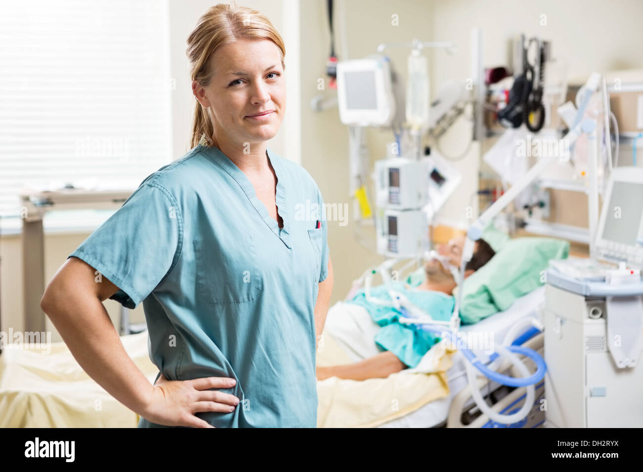 Confident Nurse With Patient Resting In Background Stock Photo - Alamy