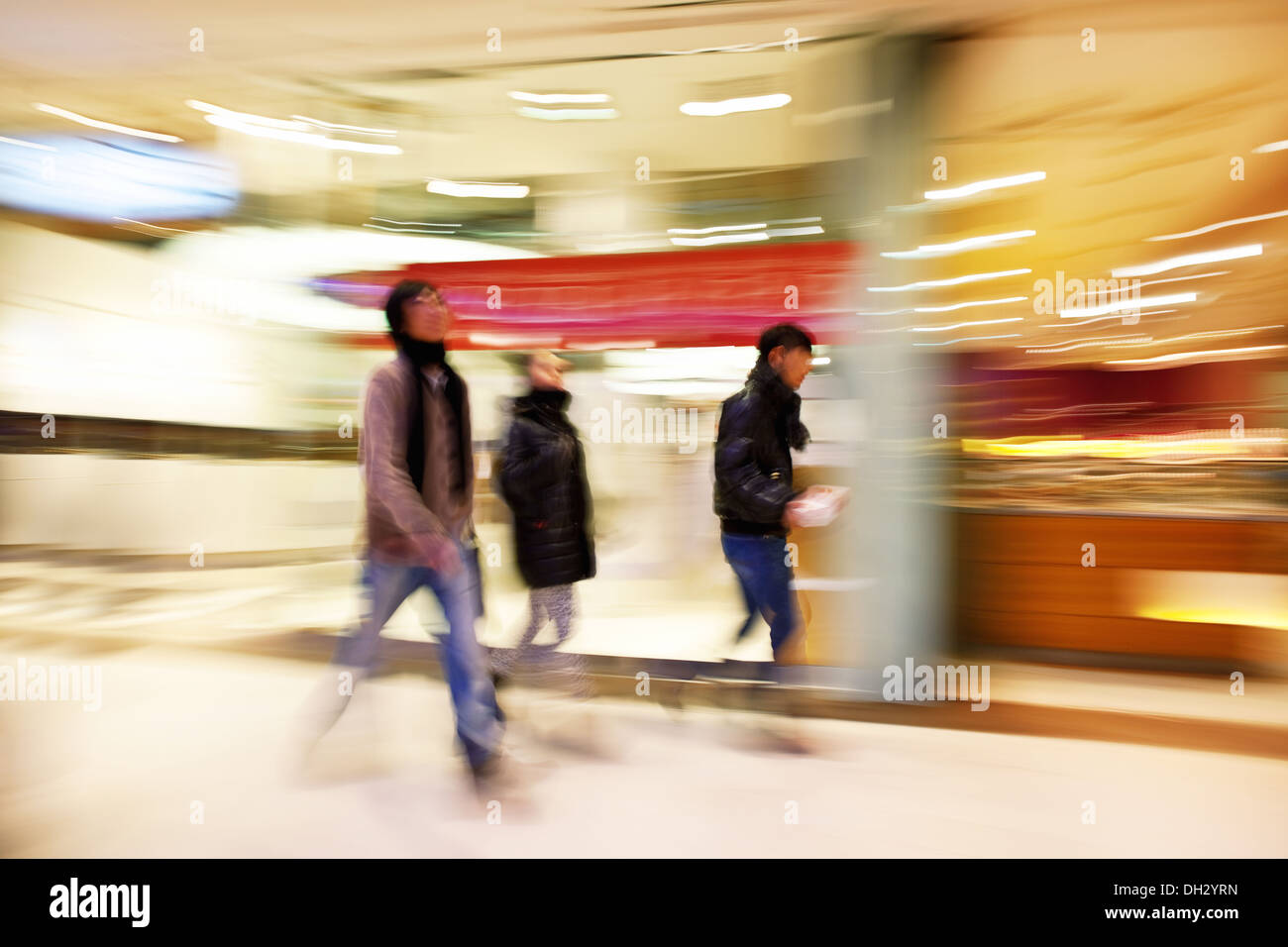 A shopper walking in front of shop window Stock Photo - Alamy