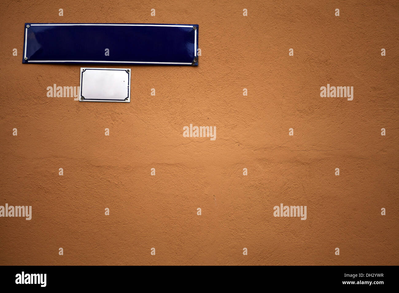 Color shot of an empty blue street sign on a green wall Stock Photo - Alamy