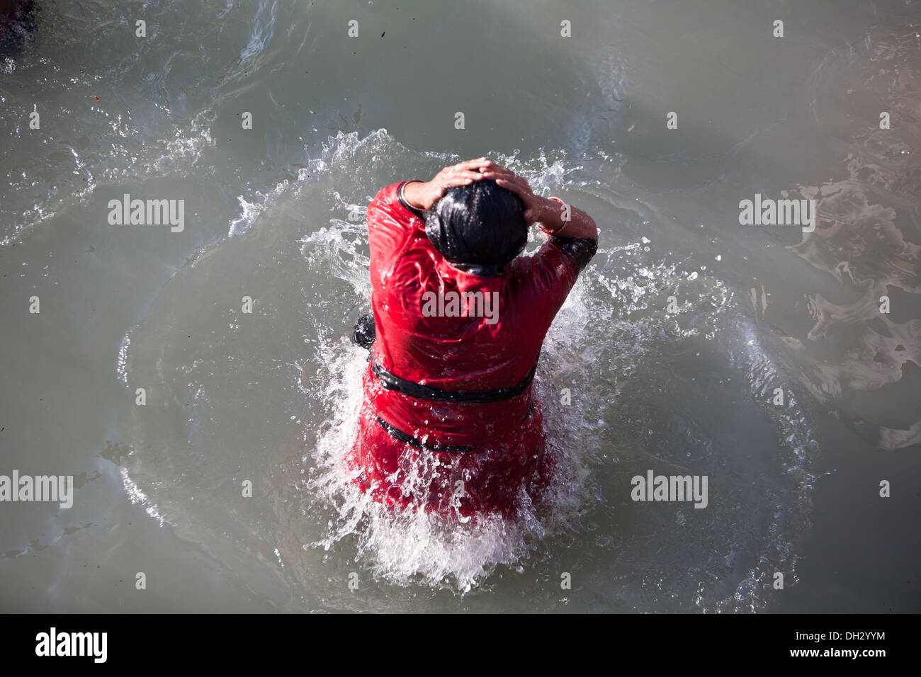 Indian woman devotee bathing taking dip in Ganga river ganges at ...