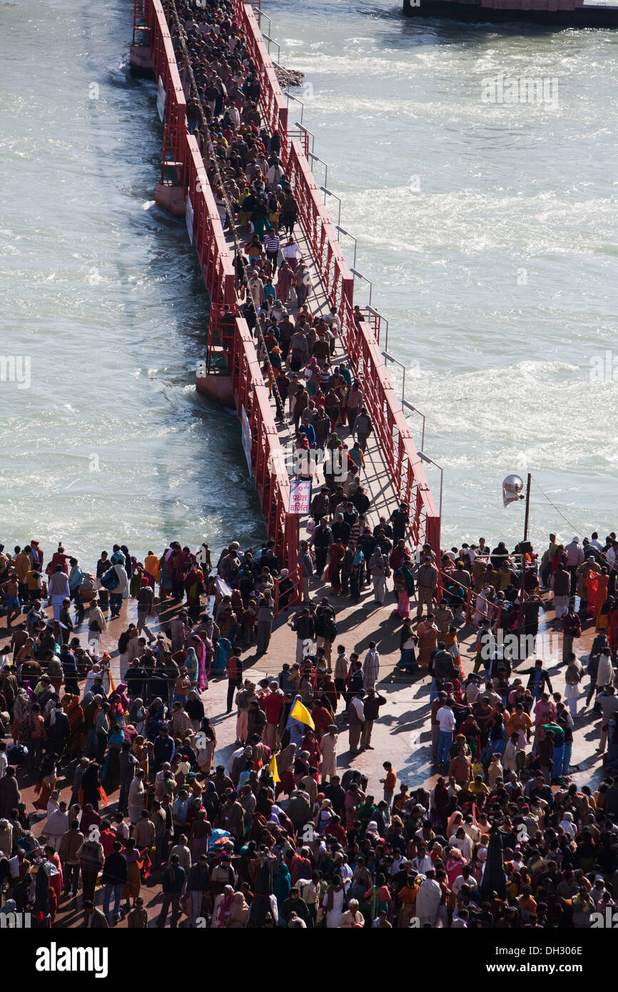 crowd of people crossing bridge on Ganga river ganges Haridwar ...
