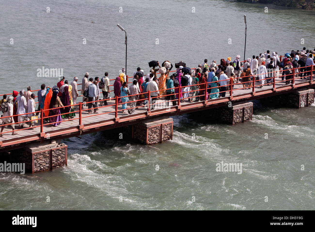 people crossing bridge on Ganga river ganges Haridwar Uttarakhand India ...