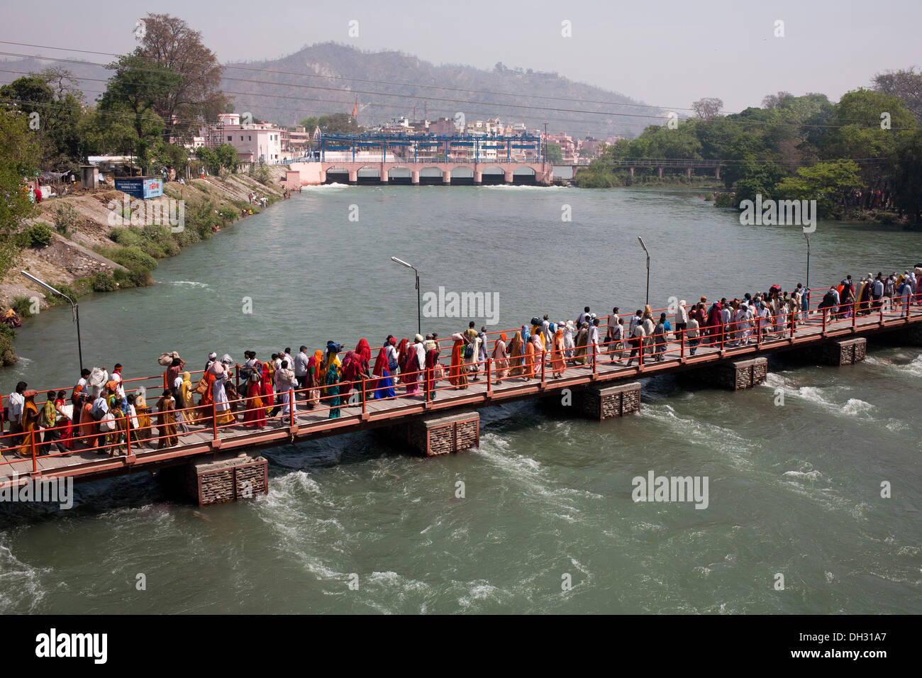 people crossing bridge on Ganga river ganges Haridwar Uttarakhand India ...
