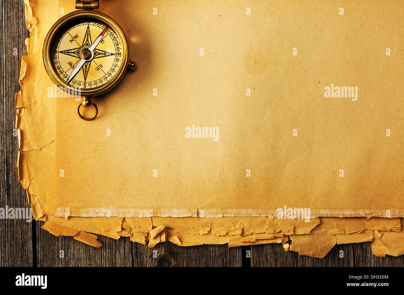 Antique brass compass over old background Stock Photo - Alamy