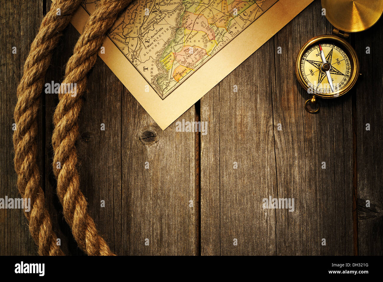Antique compass and rope over old map Stock Photo - Alamy