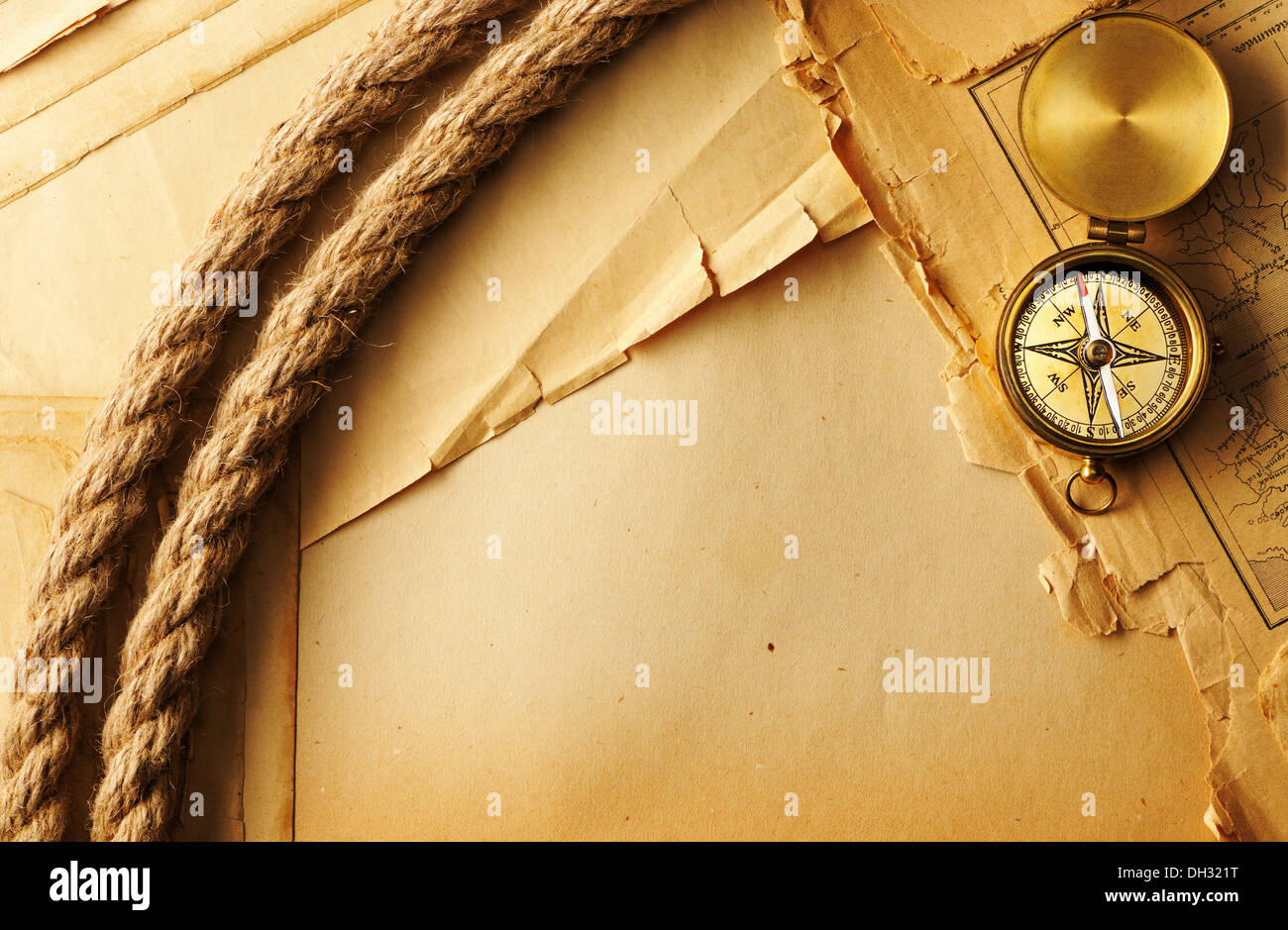 Antique compass and rope over old map Stock Photo - Alamy