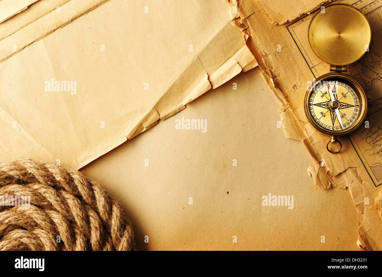 Antique compass and rope over old map Stock Photo - Alamy