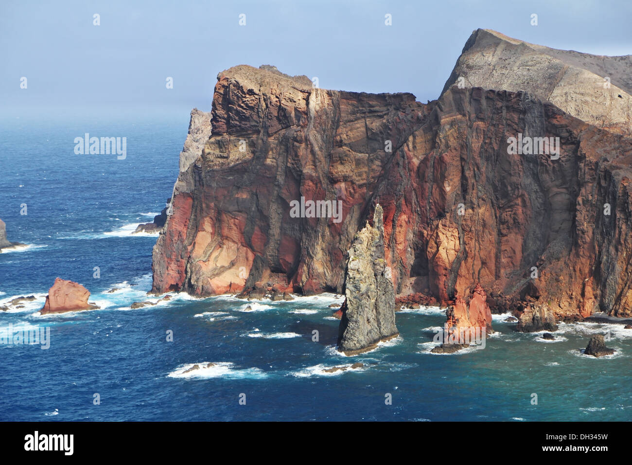 Bright red and gray coastal rocks Stock Photo - Alamy