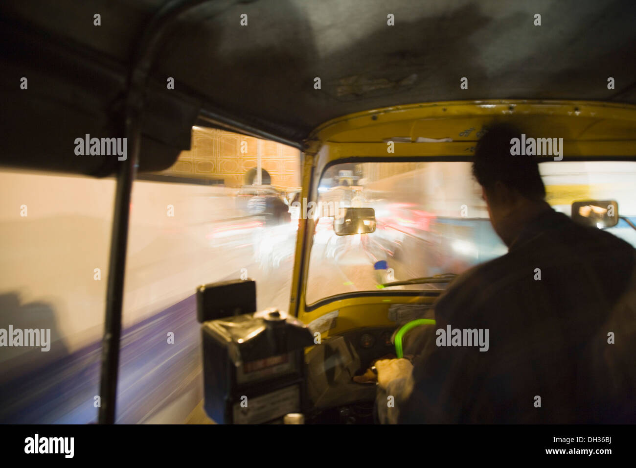 Rear view of a man driving an auto rickshaw, Jaipur, Rajasthan, India ...