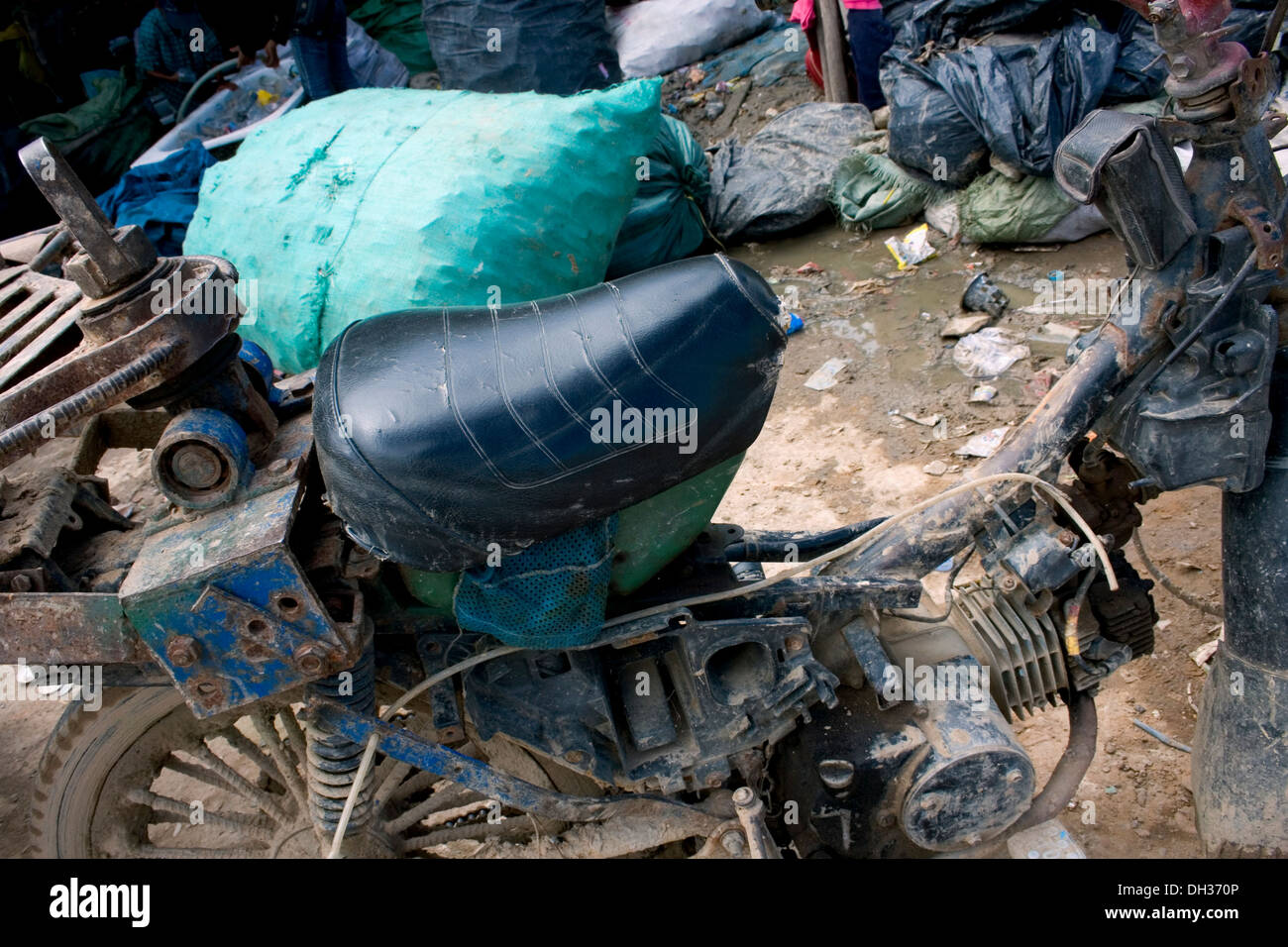 An old motorcycle used to transport recyclable material is parked in ...