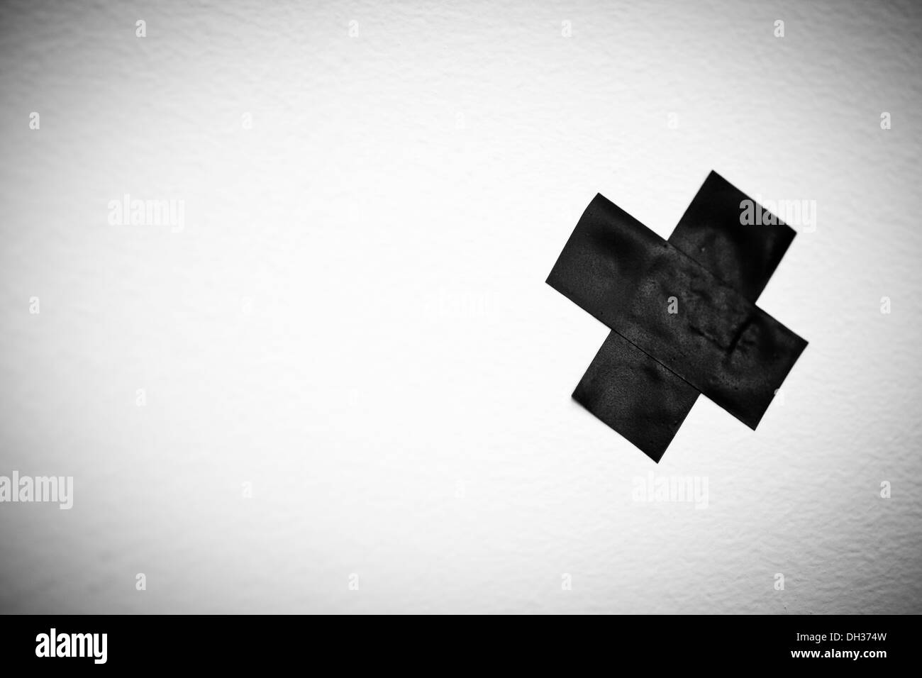 Patched up hole in the wall with electrical tape Stock Photo - Alamy