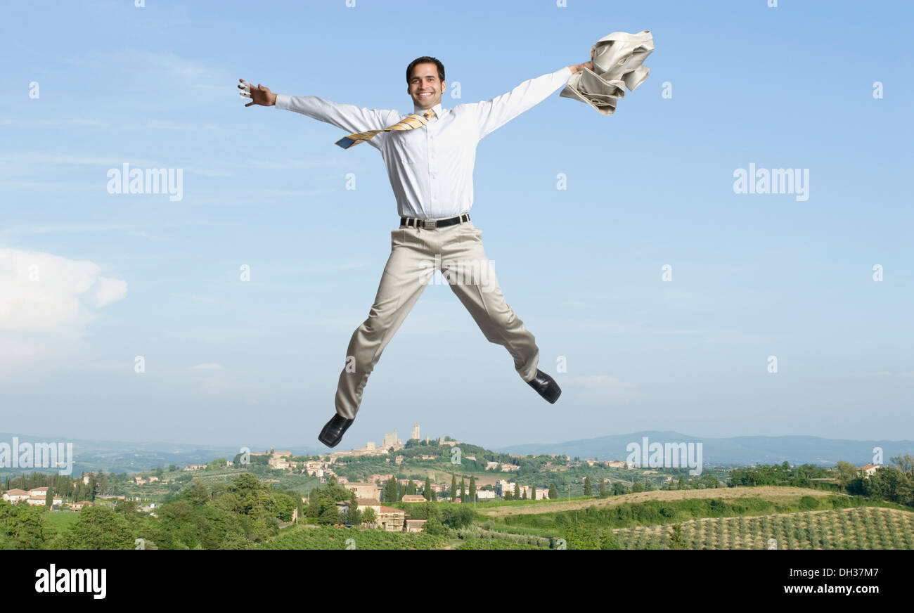 Businessman flying with his arms outstretched Stock Photo - Alamy
