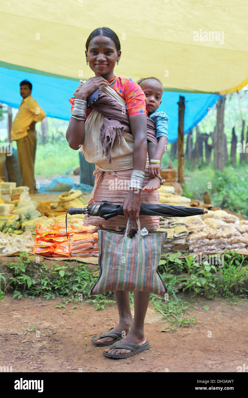Baiga mother carrying child on her back. Baiga Tribe, Chada village ...
