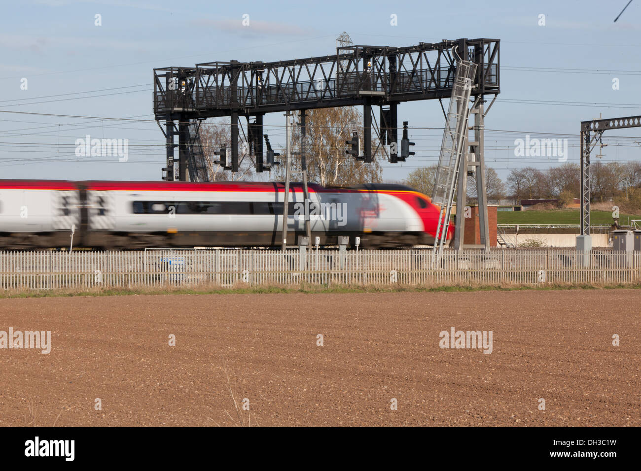 A Virgin passenger train passing signals on the West Coast Main Line ...