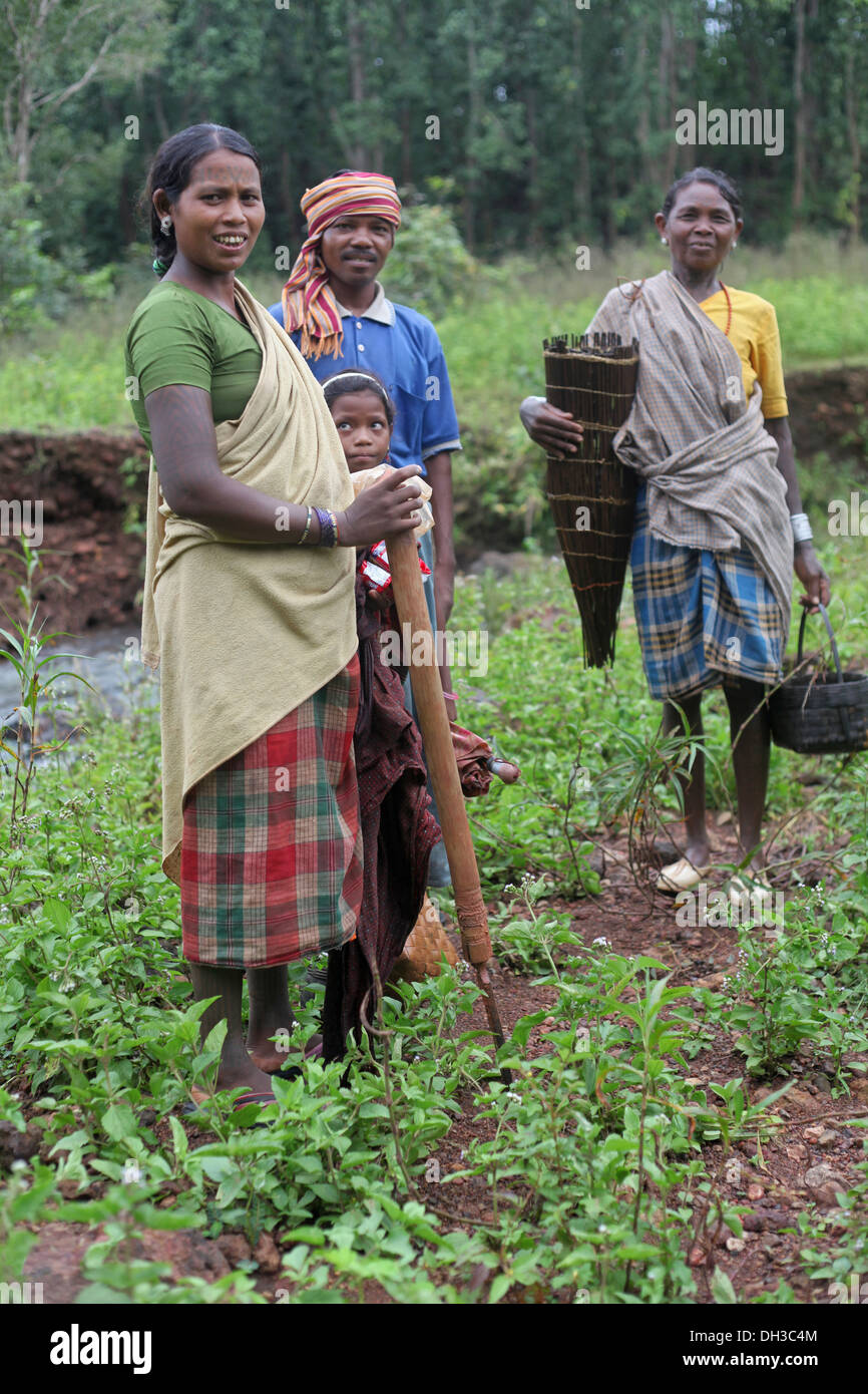 Fisherman and family with fish catching net. Baiga Tribe, Chada village ...