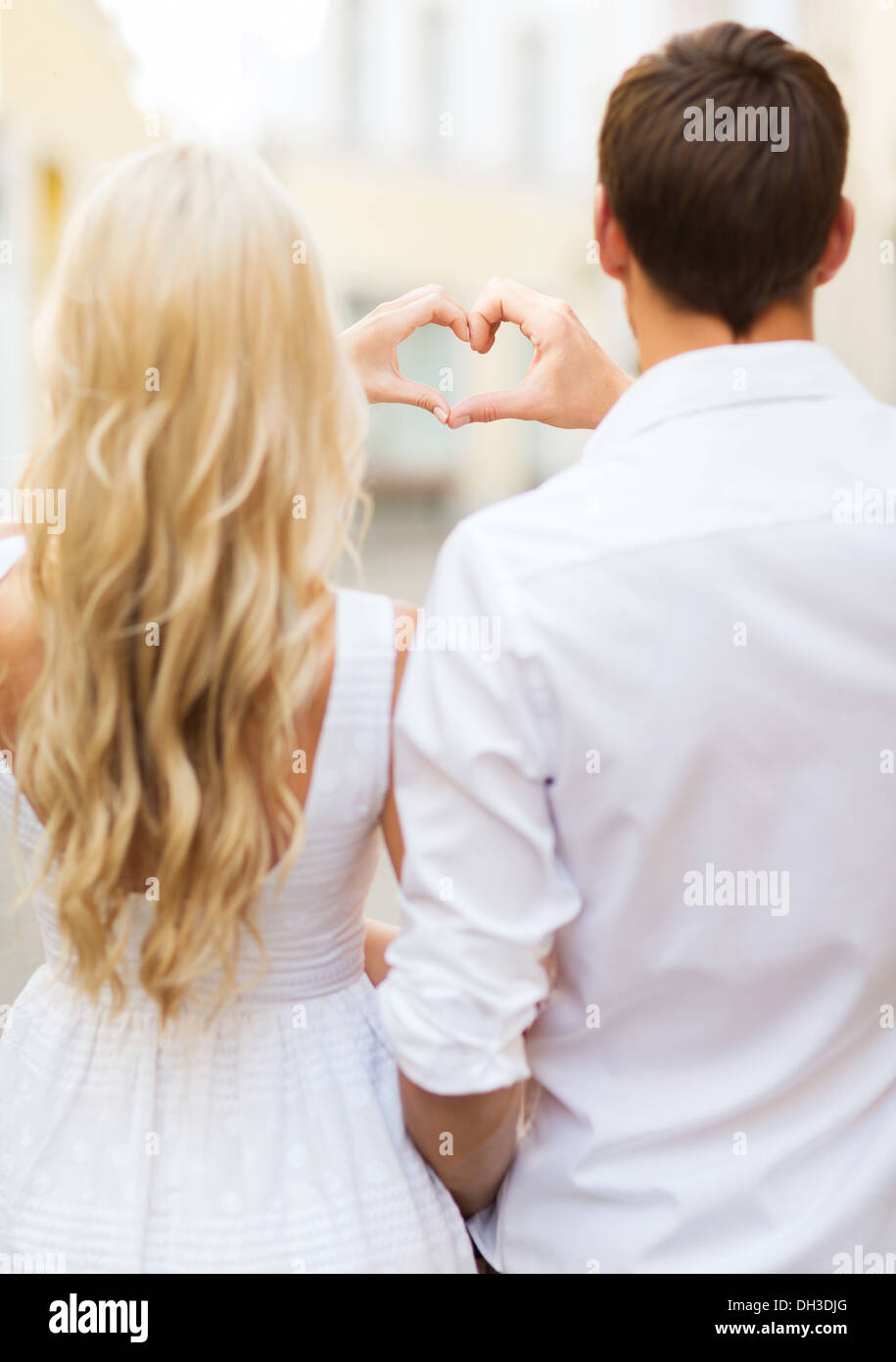 romantic couple in the city making heart shape Stock Photo - Alamy