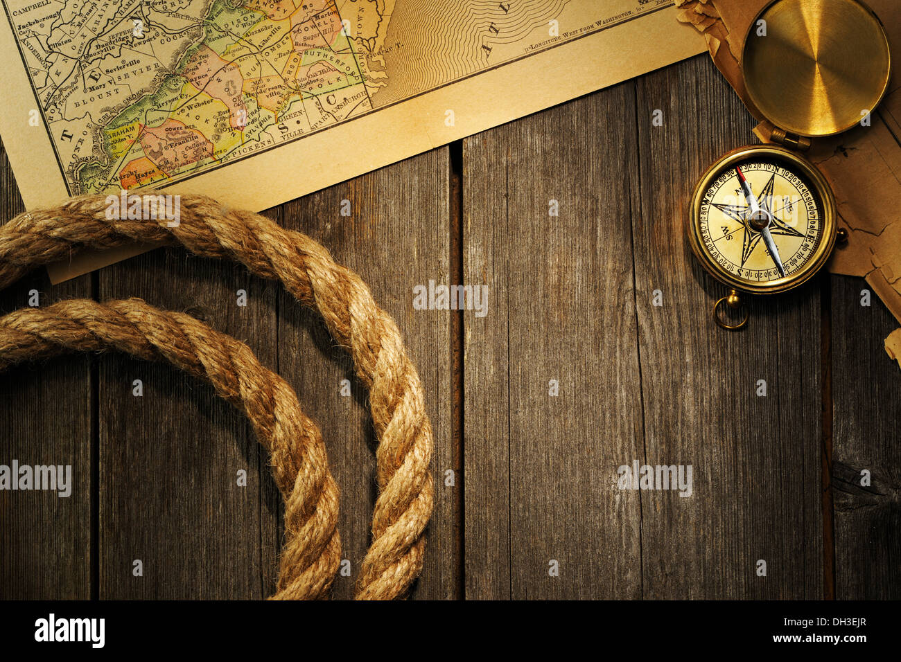 Antique compass and rope over old map Stock Photo - Alamy