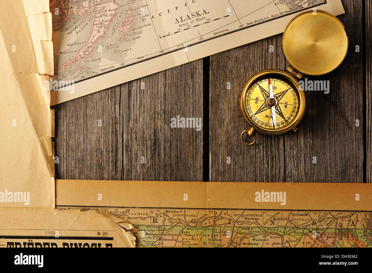 Antique compass over old map Stock Photo - Alamy