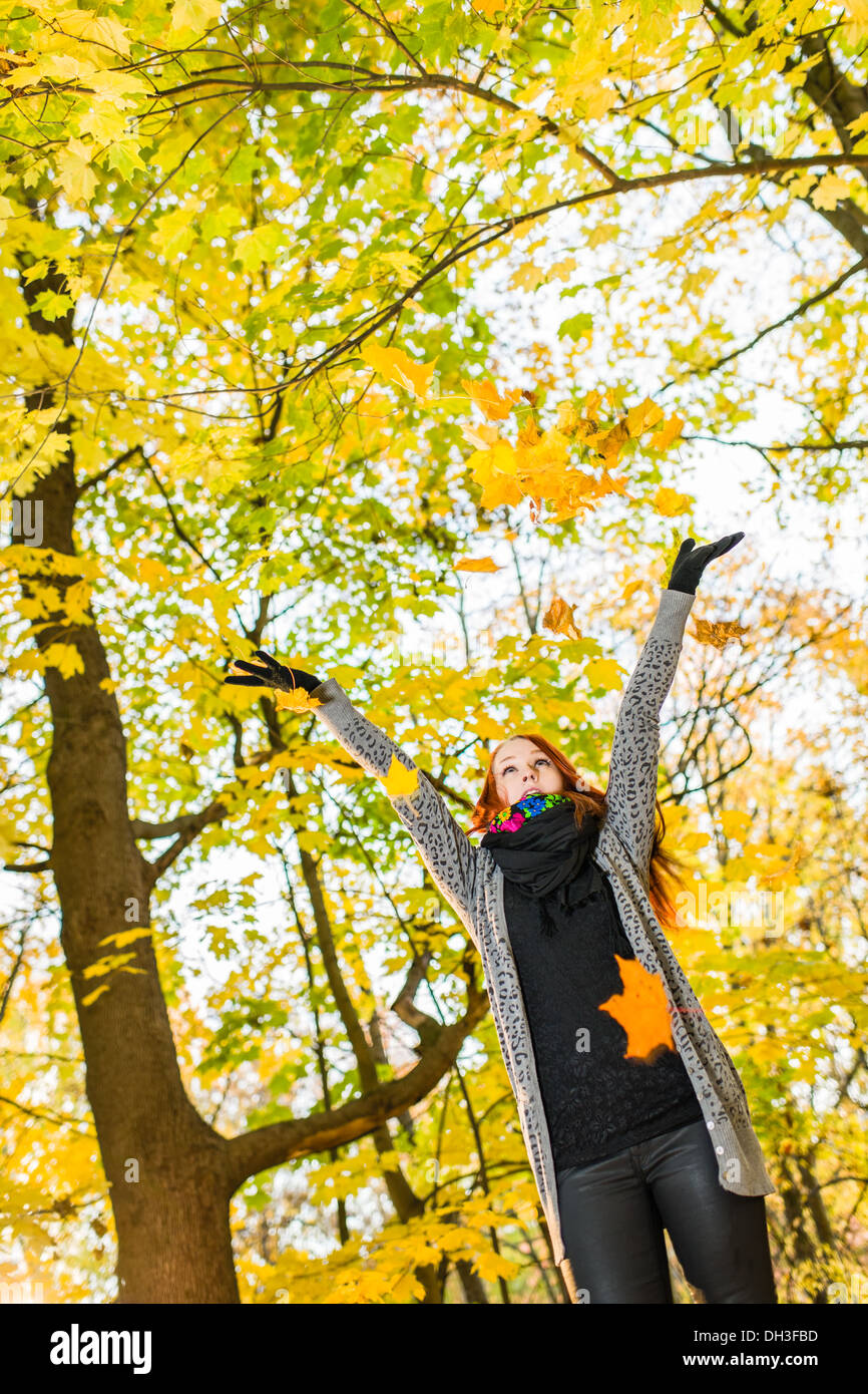 Beautiful girl and falling leaves, colors of fall Stock Photo - Alamy