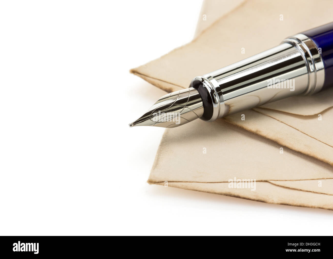 ink pen and aged paper isolated on white background Stock Photo - Alamy