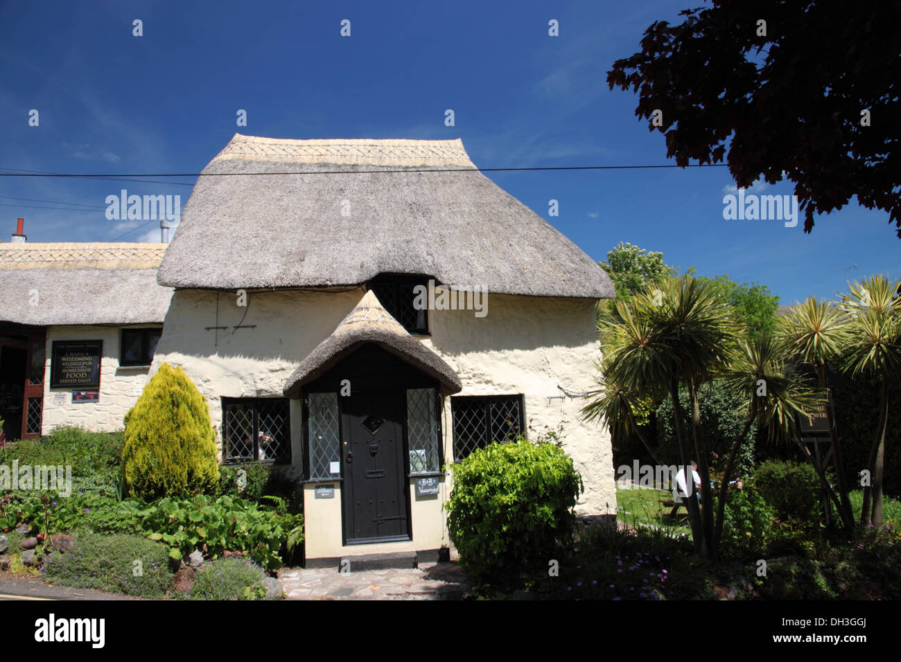 A thatched 'pub with menu board and blue skies Stock Photo - Alamy