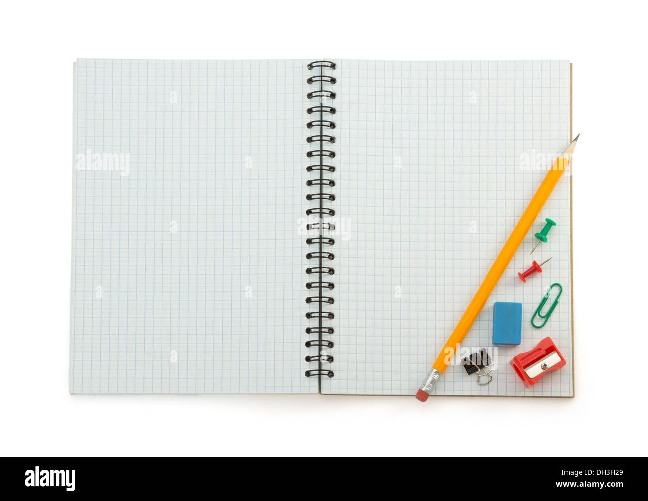 school supplies on checked notebook isolated at white background Stock ...
