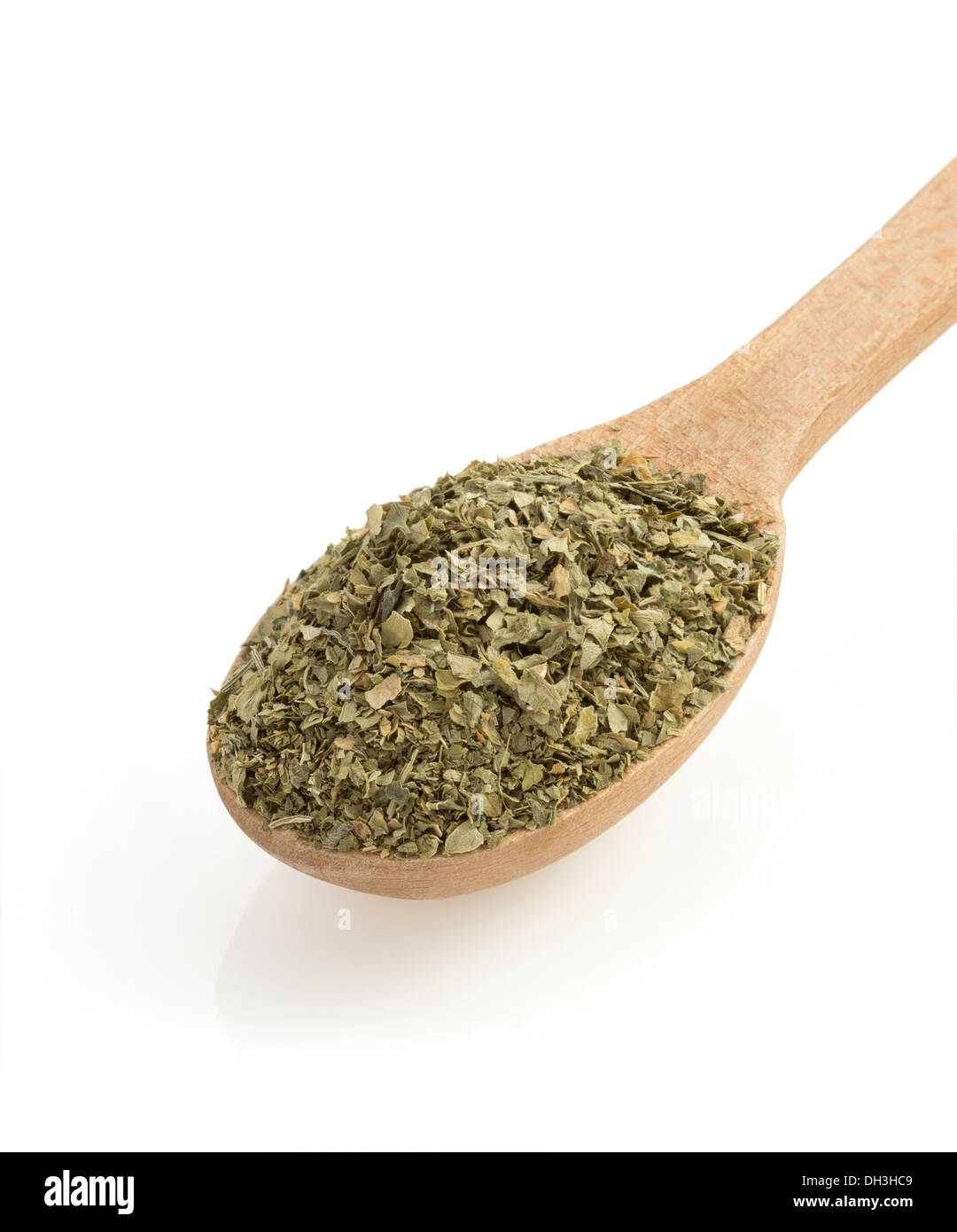 dried green spices in spoon isolated on white background Stock Photo ...