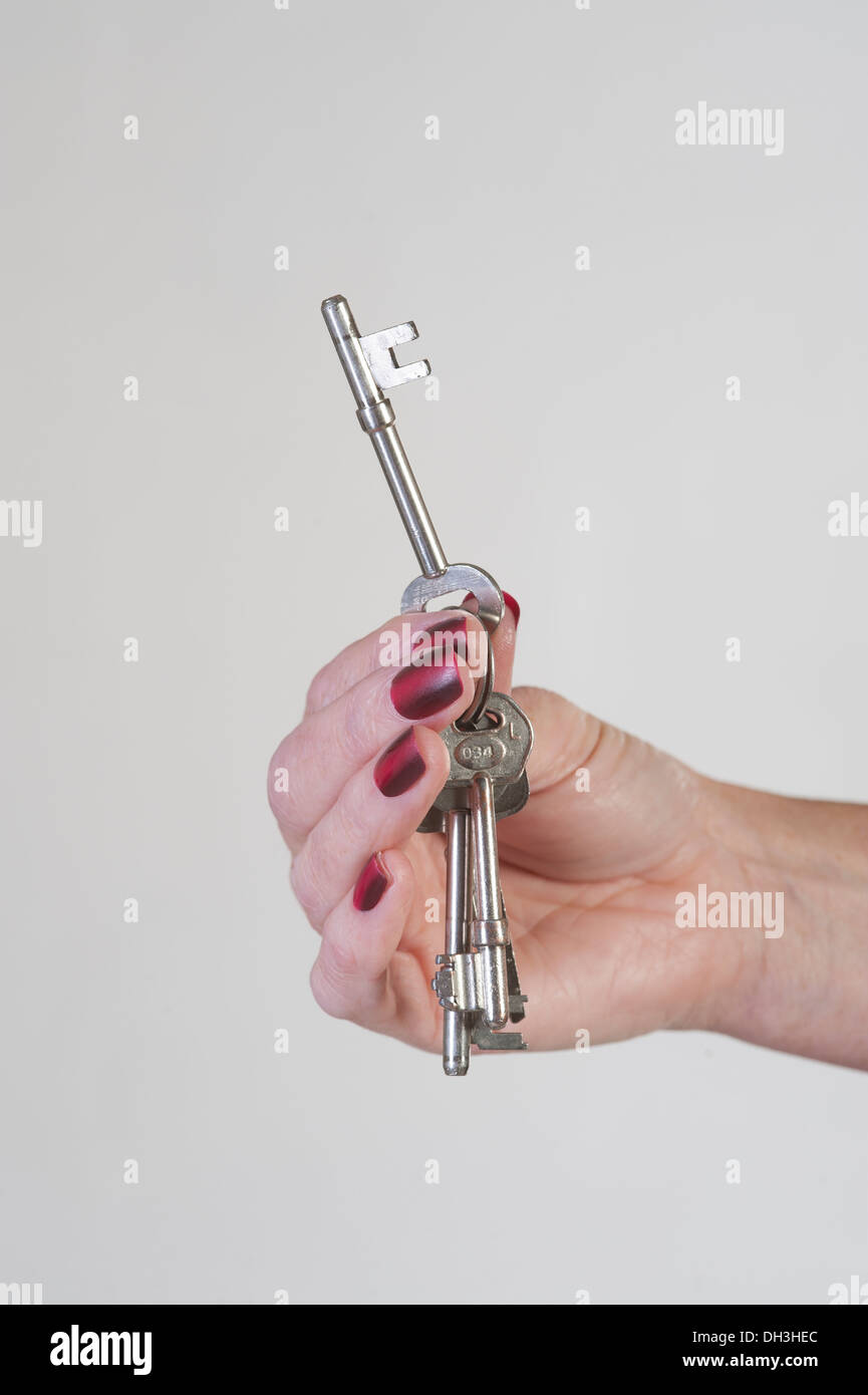 Bunch of keys in a woman's hand Stock Photo - Alamy