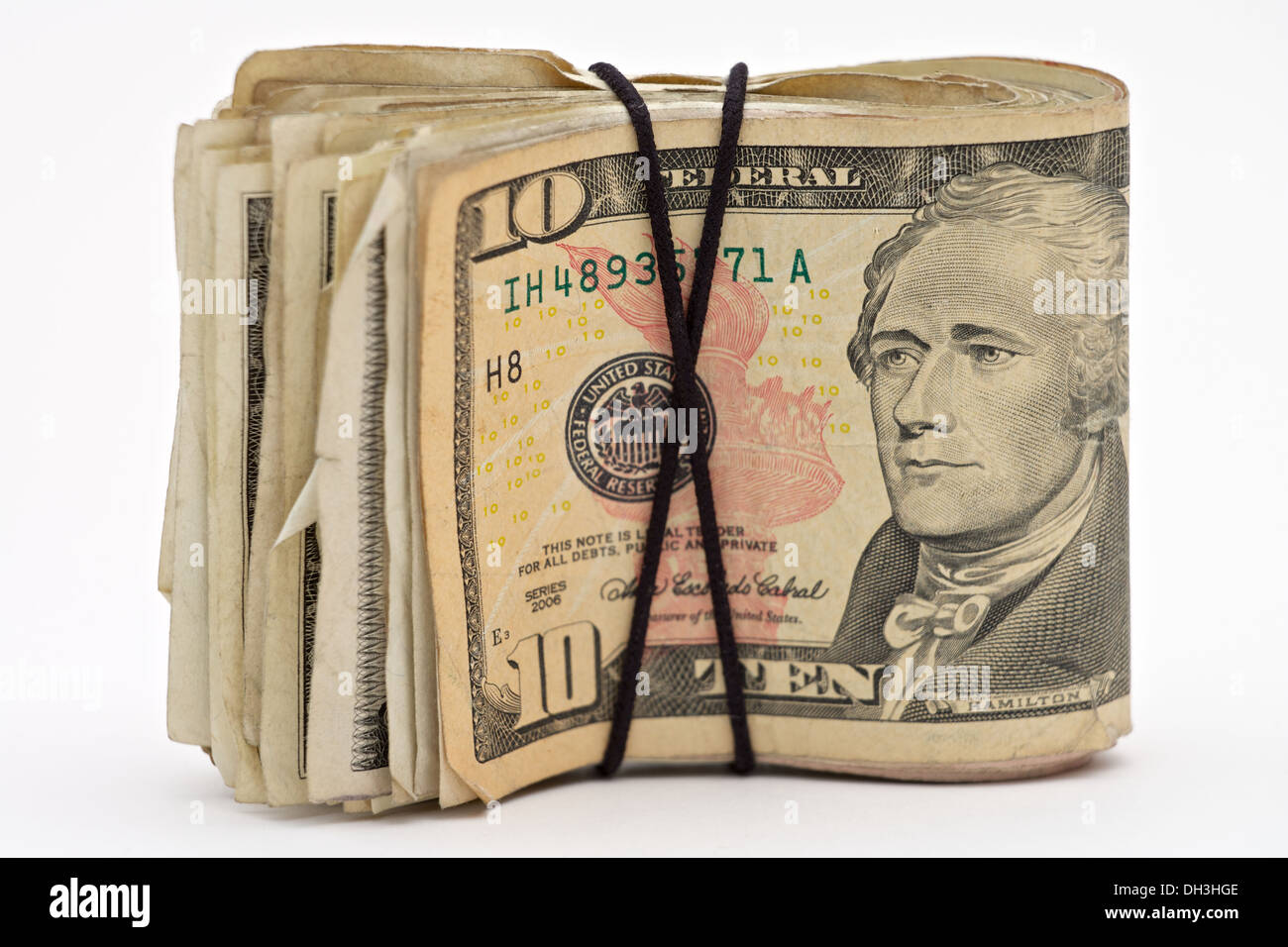 Closeup of a wad of American money tied together with a rubber band ...