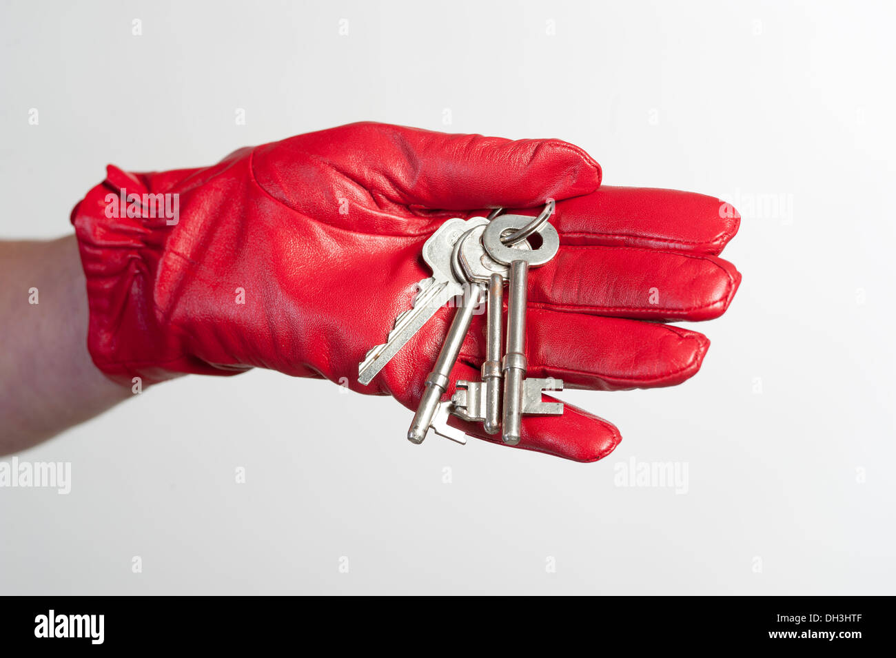 Bunch of keys in a woman's gloved hand Stock Photo - Alamy