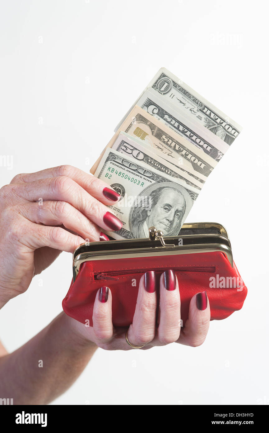 Hand in purse and notes hi-res stock photography and images - Alamy