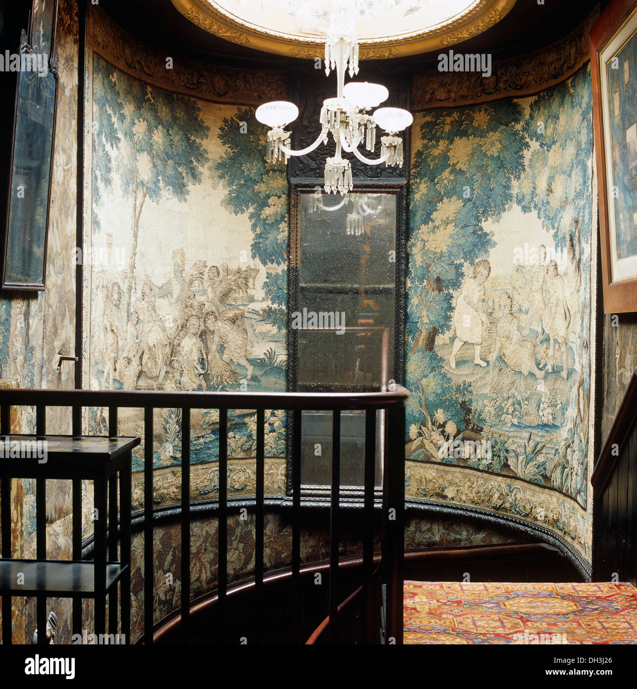 Round turret landing with large tapestries on the walls below ...