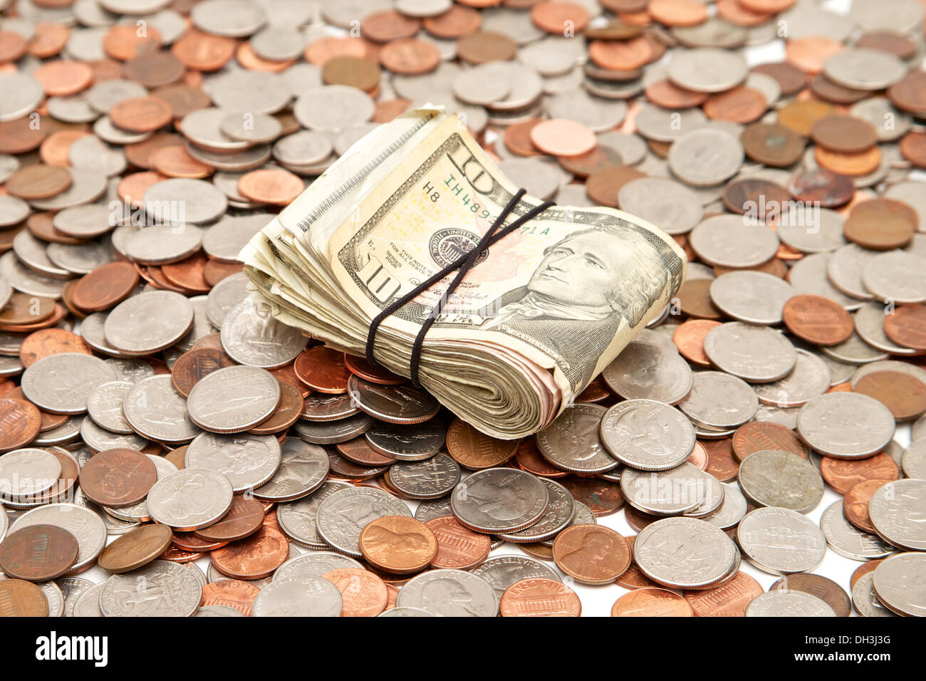 Folded and rubber banded stack of money laying on top of a pile of ...