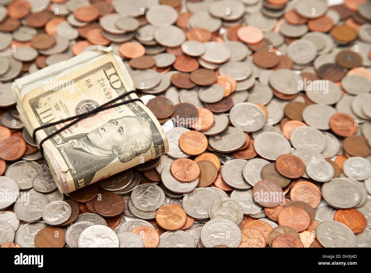 Folded and rubber banded stack of money laying on top of a pile of ...