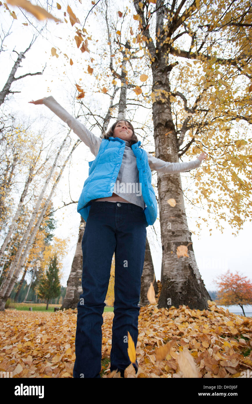 Leaves falling on girl Stock Photo - Alamy